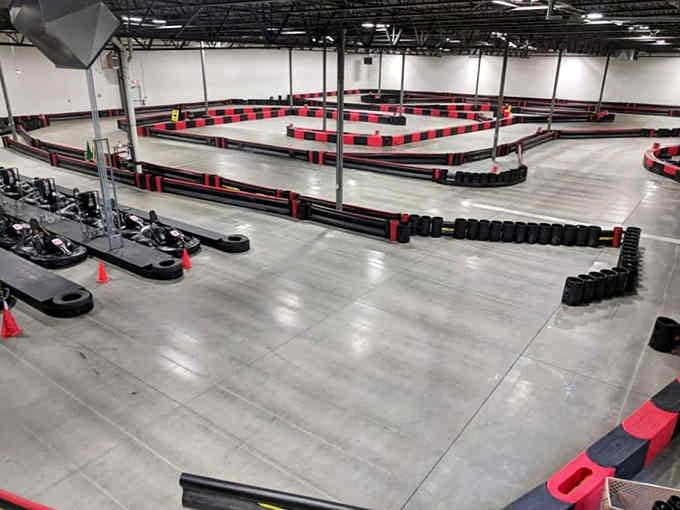 That pristine indoor track layout looks like a racing board game come to life, minus the dice.