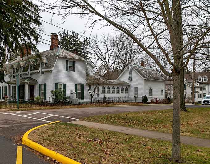 Historic homes with black shutters and white picket fences remind you that some architectural traditions never go out of style.