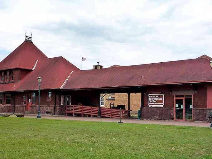 This distinctive red depot building with its unique roofline looks like something from a storybook railway adventure.