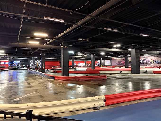Red barriers line this cavernous track where the echo of electric motors creates its own symphony of speed.