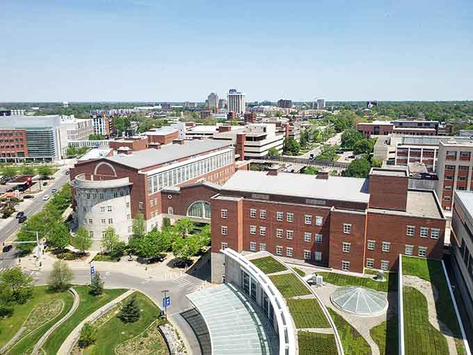 The university campus stretches across the cityscape, bringing youthful energy to these well-maintained brick buildings and lawns.