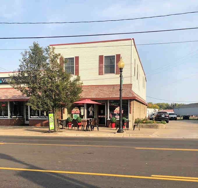 The classic corner building with outdoor seating captures small-town charm where neighbors gather over great food and conversation.