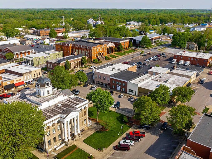 Tree-lined streets and brick buildings create a downtown tapestry where past and present weave together seamlessly from above.