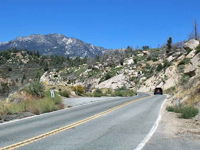 Snow-dusted peaks tower above this winding route, making you feel pleasantly small in the best possible way.