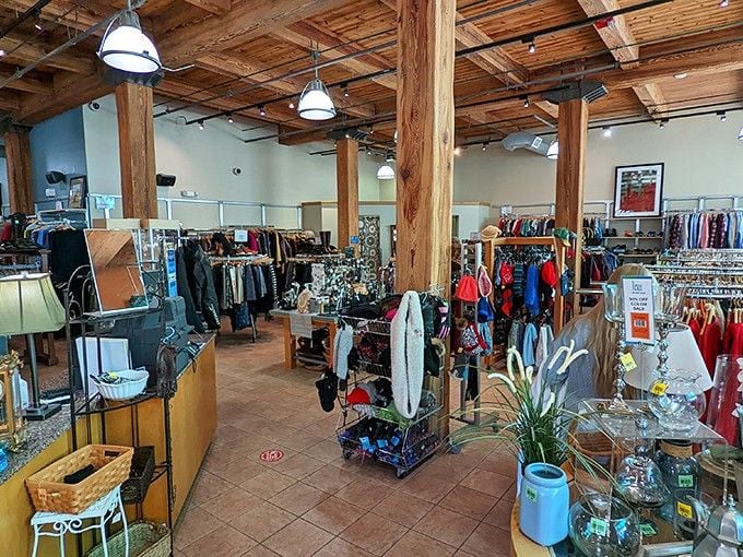 Rich wooden beams overhead and colorful scarves below create a shopping atmosphere that feels more like a cozy loft than a thrift store.