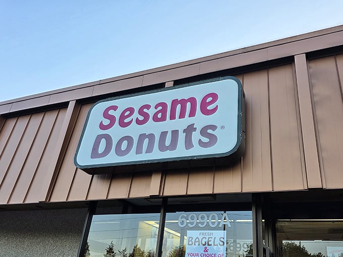 That retro sign against brown siding whispers of neighborhood tradition, where bagels and donuts share equal billing with pride.