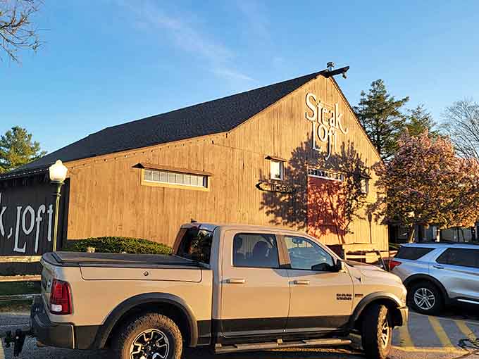 Golden hour light on weathered wood signals that something delicious is cooking behind those barn doors.