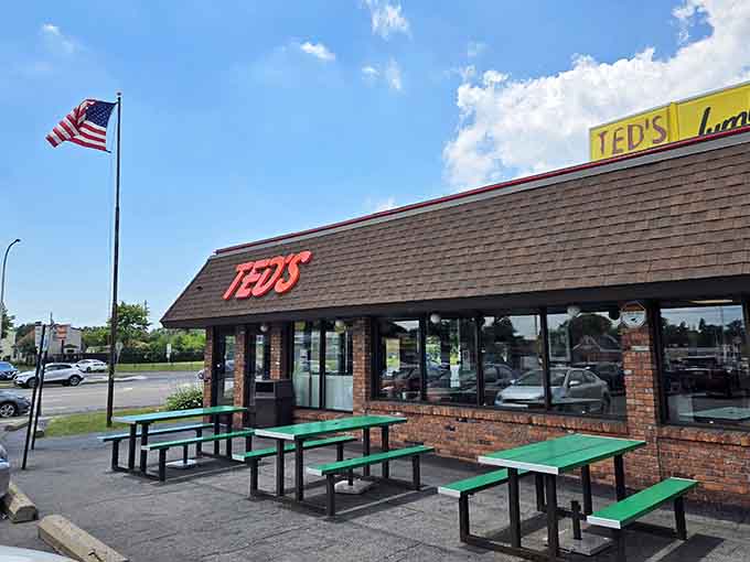 Those green picnic tables under the American flag capture everything great about summer dining in one perfect snapshot.