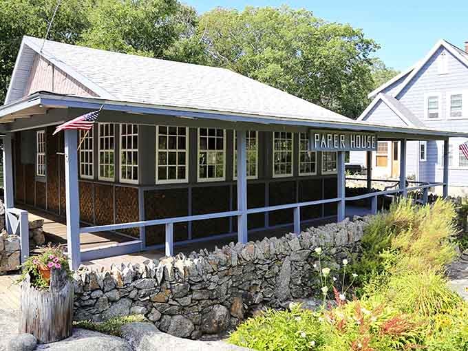 Stone walls and careful landscaping frame this quirky cottage where yesterday's news became today's walls and furniture.
