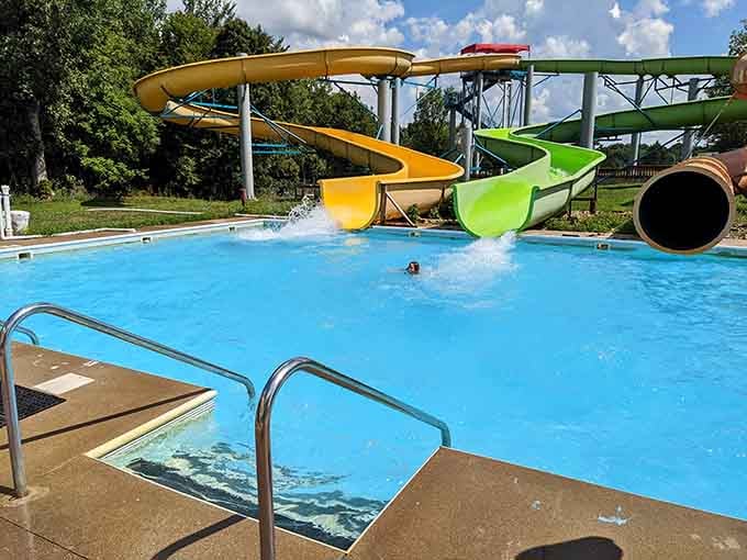 Someone's making a splash while green trees frame this perfect summer scene that belongs on a postcard.