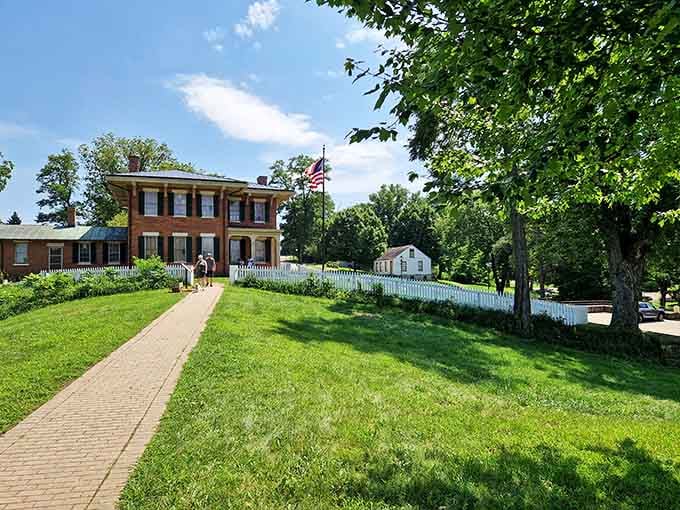 The white picket fence and manicured lawn frame this historic residence perfectly, like a postcard from a gentler era.