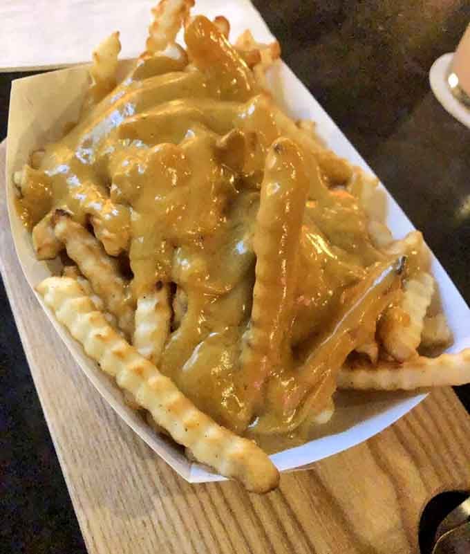 Crinkle-cut fries drowning in gravy, proof that sometimes the messiest dishes are the most satisfying.