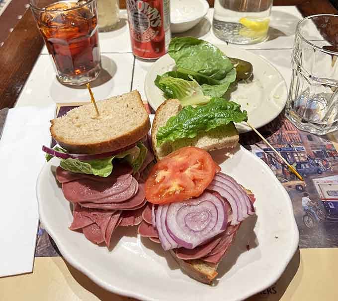 This triple-decker masterpiece requires both hands, strategic planning, and possibly a structural engineer to consume properly and safely.
