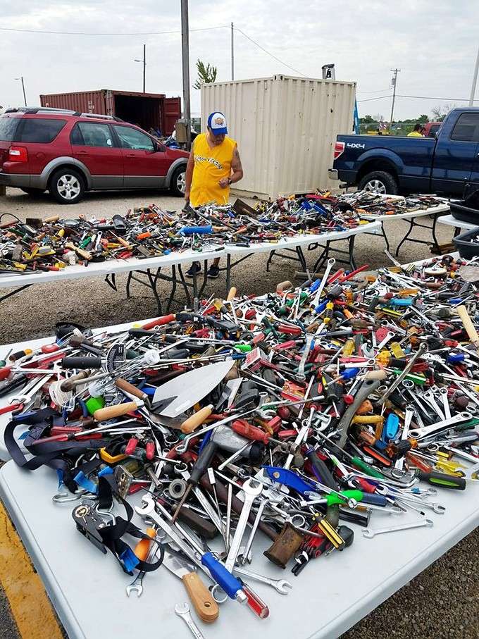 This tool collection looks like someone raided every garage in Wisconsin and spread the bounty across three tables.