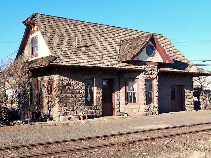 The old railway depot sits quietly by the tracks, remembering when trains connected this remote outpost to the wider world.