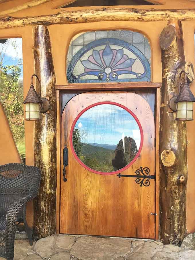 The round portal window frames mountain views like a living painting that changes with every passing cloud.