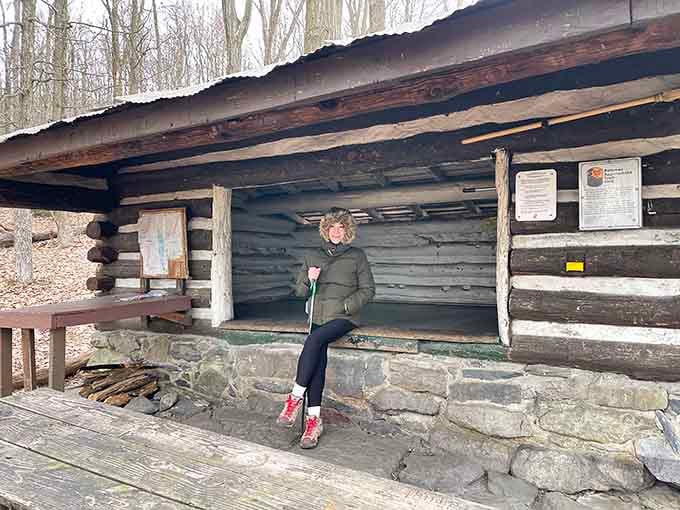 The Pine Knob Shelter welcomes weary hikers with rustic charm and stories carved into its weathered logs.