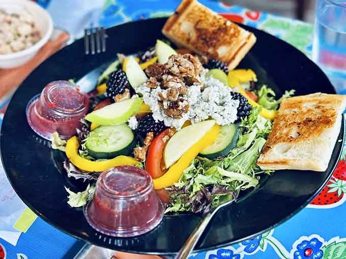 Fresh salad loaded with berries and blue cheese proves barbecue joints can do vegetables with style too.