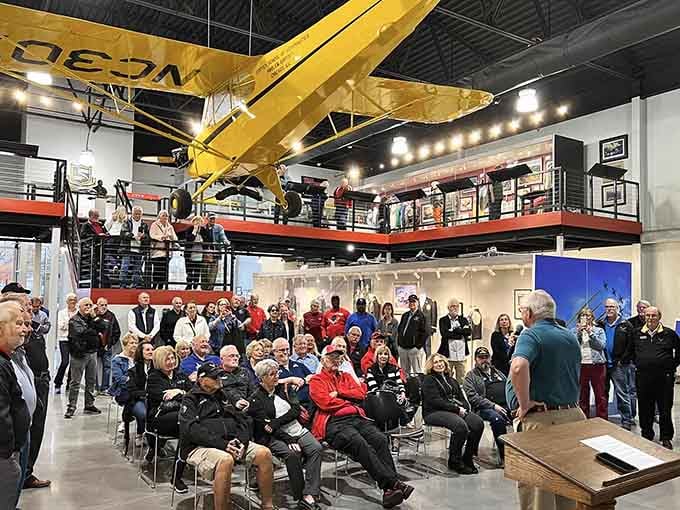 Inside, a yellow biplane hangs overhead like a guardian angel watching over aviation's greatest stories below.