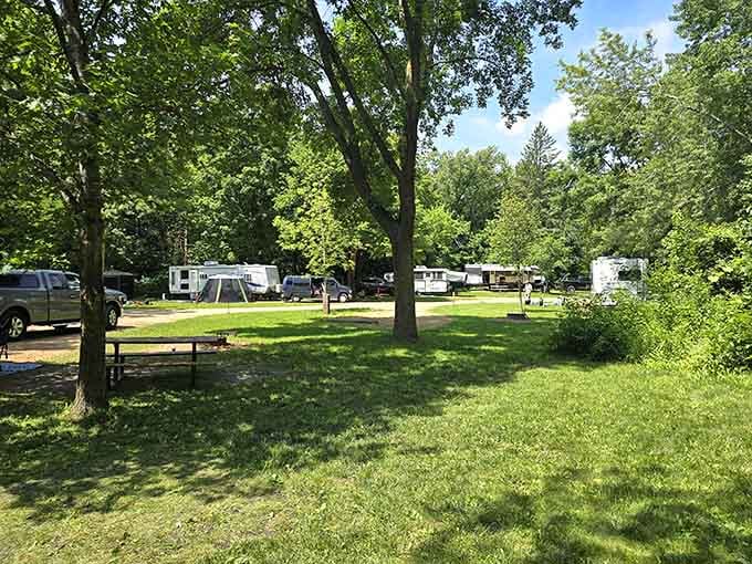 The campground offers shaded sites where families create memories and debate whether the tent poles go here or there.