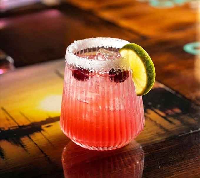 Pink margaritas with salt rims and lime wedges, because sometimes the classics don't need reinventing at all.