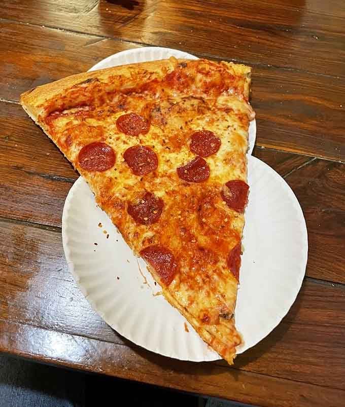 Those pepperoni circles dot a landscape of cheese that stretches farther than your arms can comfortably reach.