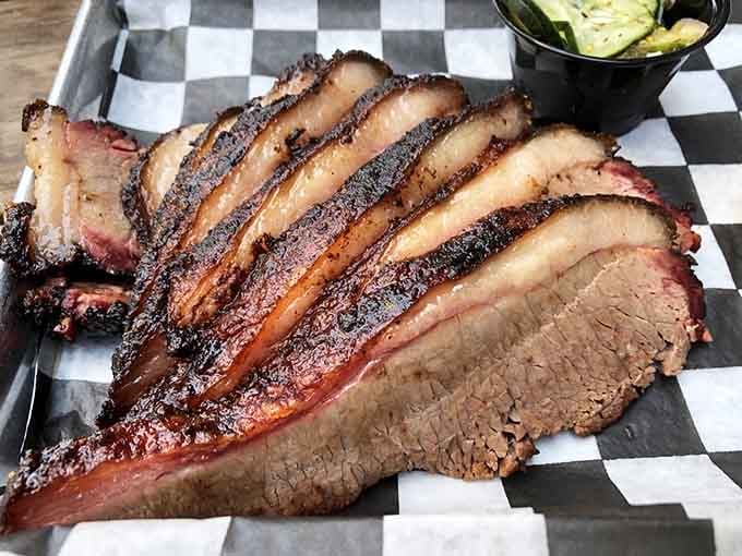 That perfect smoke ring and tender slices reveal brisket that's been treated with the respect it deserves, hours in the making.