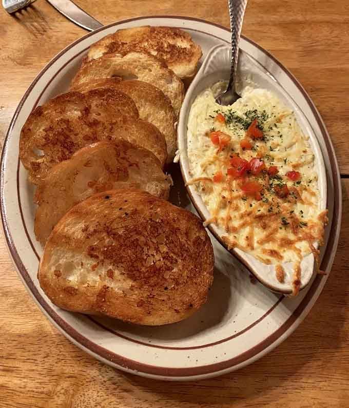 Artichoke dip with garlic bread is the kind of starter that makes you question whether you saved enough room for dinner.