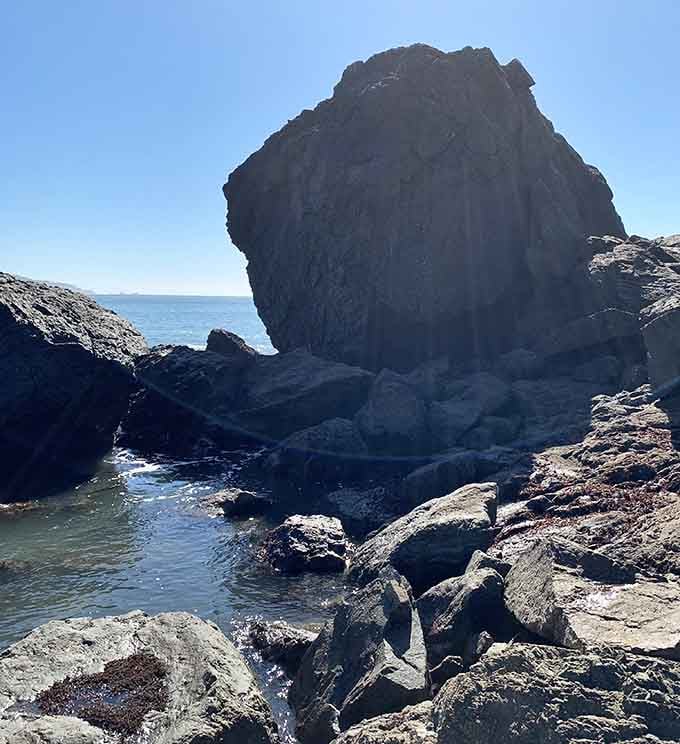 This massive rock formation stands guard over the cove like a geological bouncer checking IDs.
