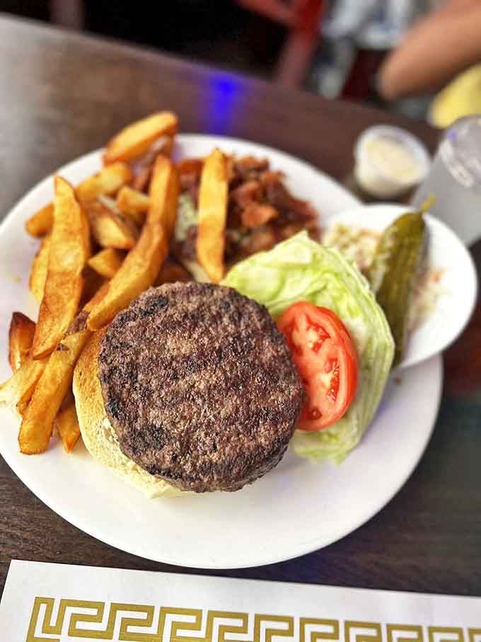 The Blue Cheese Burger arrives like it's auditioning for a food magazine cover, complete with perfectly golden fries.