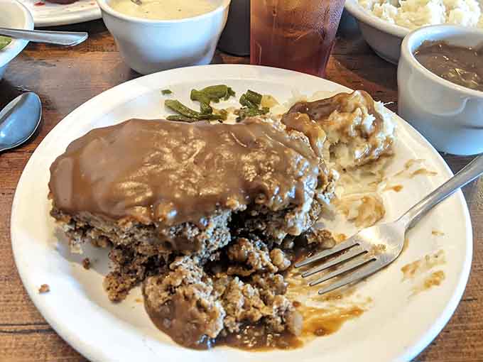 Meatloaf smothered in brown gravy is the kind of plate that reminds you why comfort food earned its name.