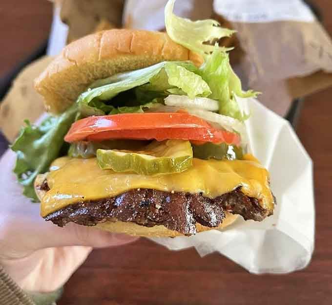 Look at that perfectly melted cheese cascading over the beef like a delicious yellow waterfall of joy.