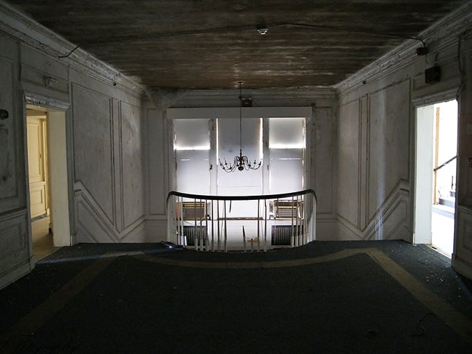 That chandelier hanging on for dear life tells you everything about the craftsmanship that built this place.