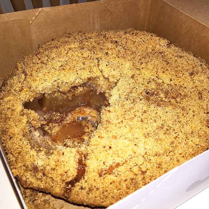 This is what pie perfection looks like, folks – flaky crust meeting fruit-filled dreams in a cardboard box of joy.