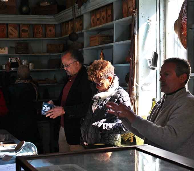 Modern visitors absorbing history where countless others stood seeking goods and perhaps whispered hope for freedom.