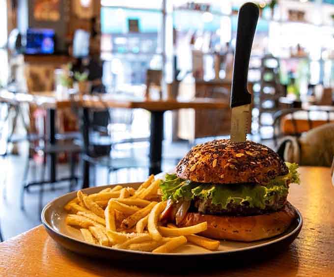 That burger comes with a knife stuck in it like Excalibur, except pulling it out makes you king of lunch.