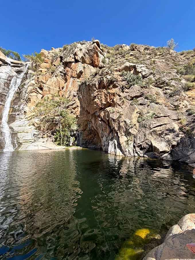 Towering rock walls frame the falls like nature's own cathedral, making you feel wonderfully small in the best way.