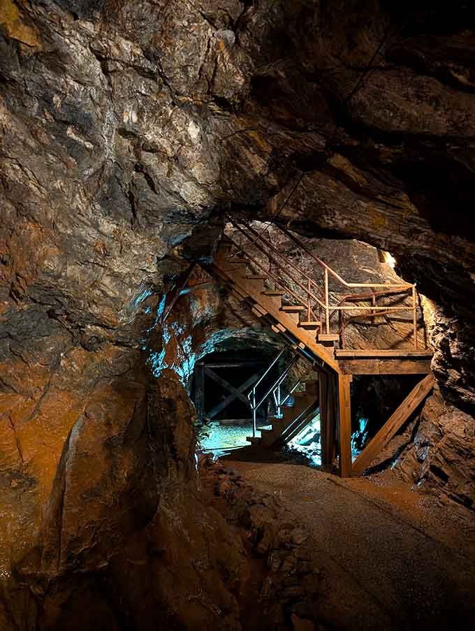 Wooden stairs lead deeper into the earth, each step taking you further from the modern world above.