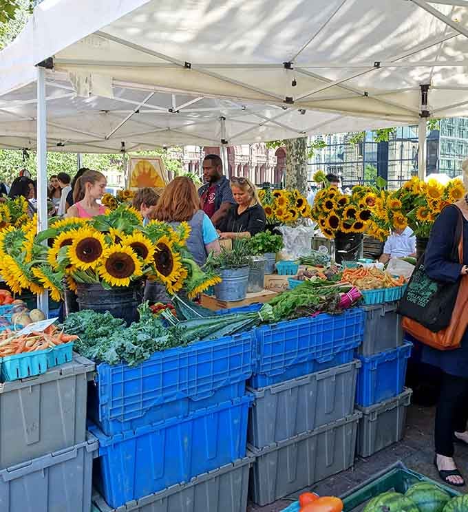 Sunflowers stand guard over fresh vegetables like the world's cheeriest security system for your dinner ingredients.