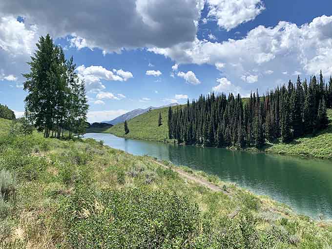 Meridian Lake reflects the surrounding peaks like nature's own mirror, creating double the mountain beauty effortlessly.