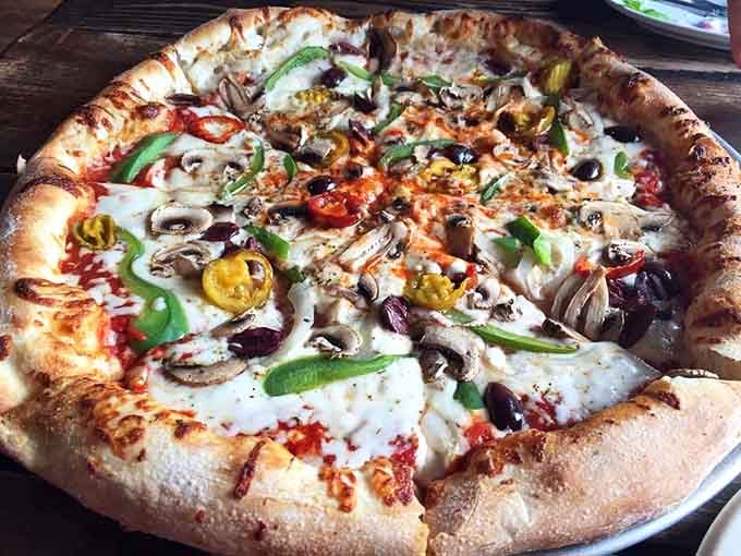 Who says vegetarian pizza can't be exciting? This colorful masterpiece proves the doubters spectacularly wrong every time.