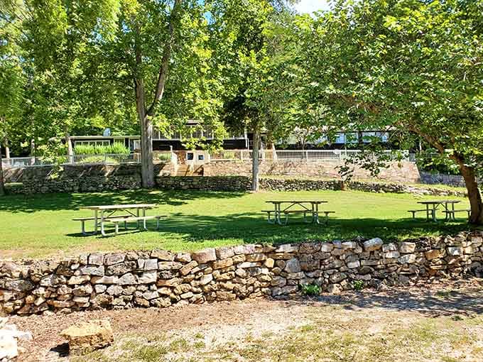 Shaded picnic spots with stone walls provide the perfect lunch venue overlooking peaceful waters.