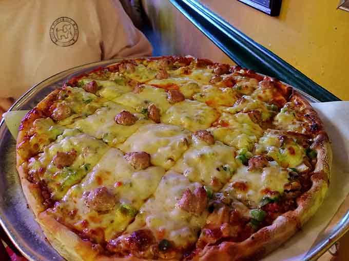 When you can't decide on toppings, just order everything; this loaded masterpiece makes commitment issues disappear.