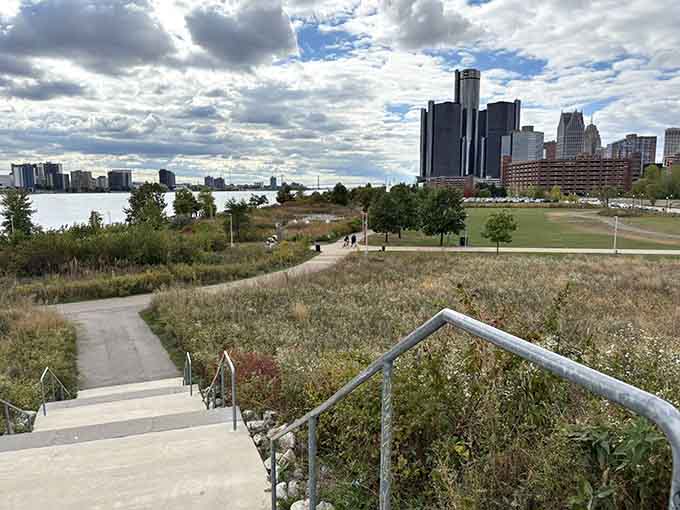 The skyline rises in the distance while native grasses sway, creating Detroit's own urban prairie experience.