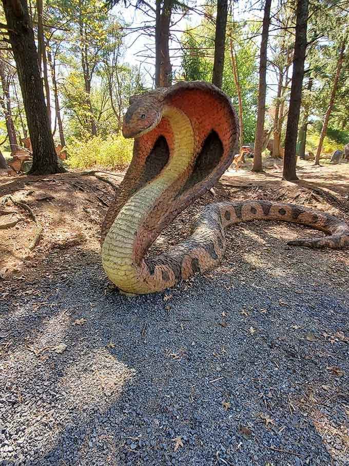 A cobra sculpture coiled and ready to strike, because apparently dinosaurs needed some reptilian backup around here.