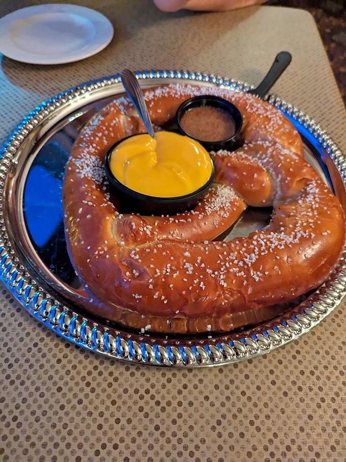 A giant salted pretzel with mustard is the kind of appetizer that makes you reconsider your entire meal strategy.
