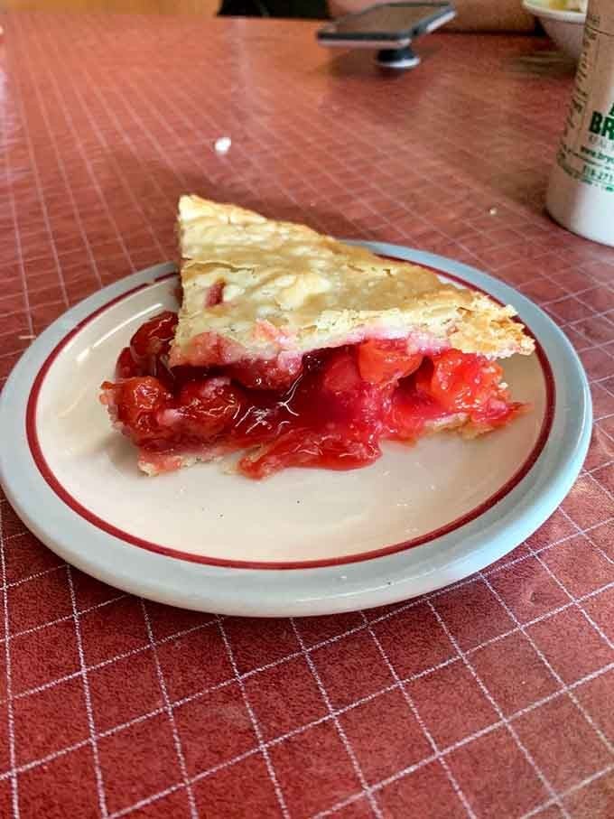Cherry pie so vibrant it practically glows, served with vanilla ice cream because some combinations are simply meant to be.