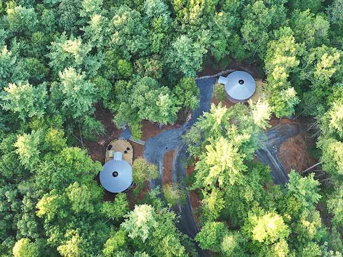 From above, the yurts nestle into the forest like perfectly placed mushrooms in nature's own secret garden.