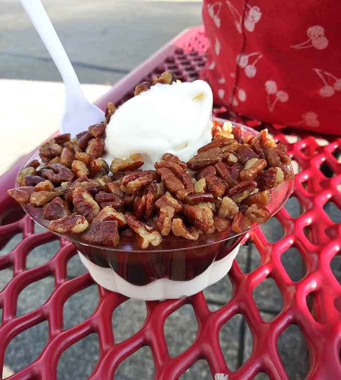 The turtle sundae arrives loaded with pecans and caramel, looking like it could solve all your problems simultaneously.