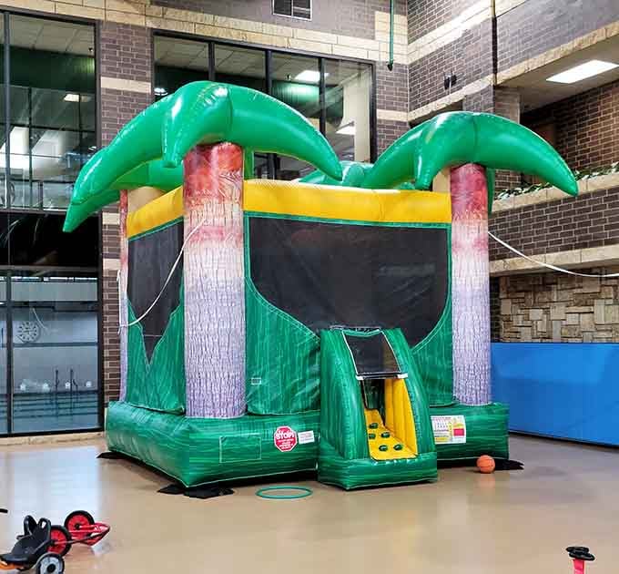 Even the bounce house gets the tropical treatment here, because why should palm trees have all the fun?